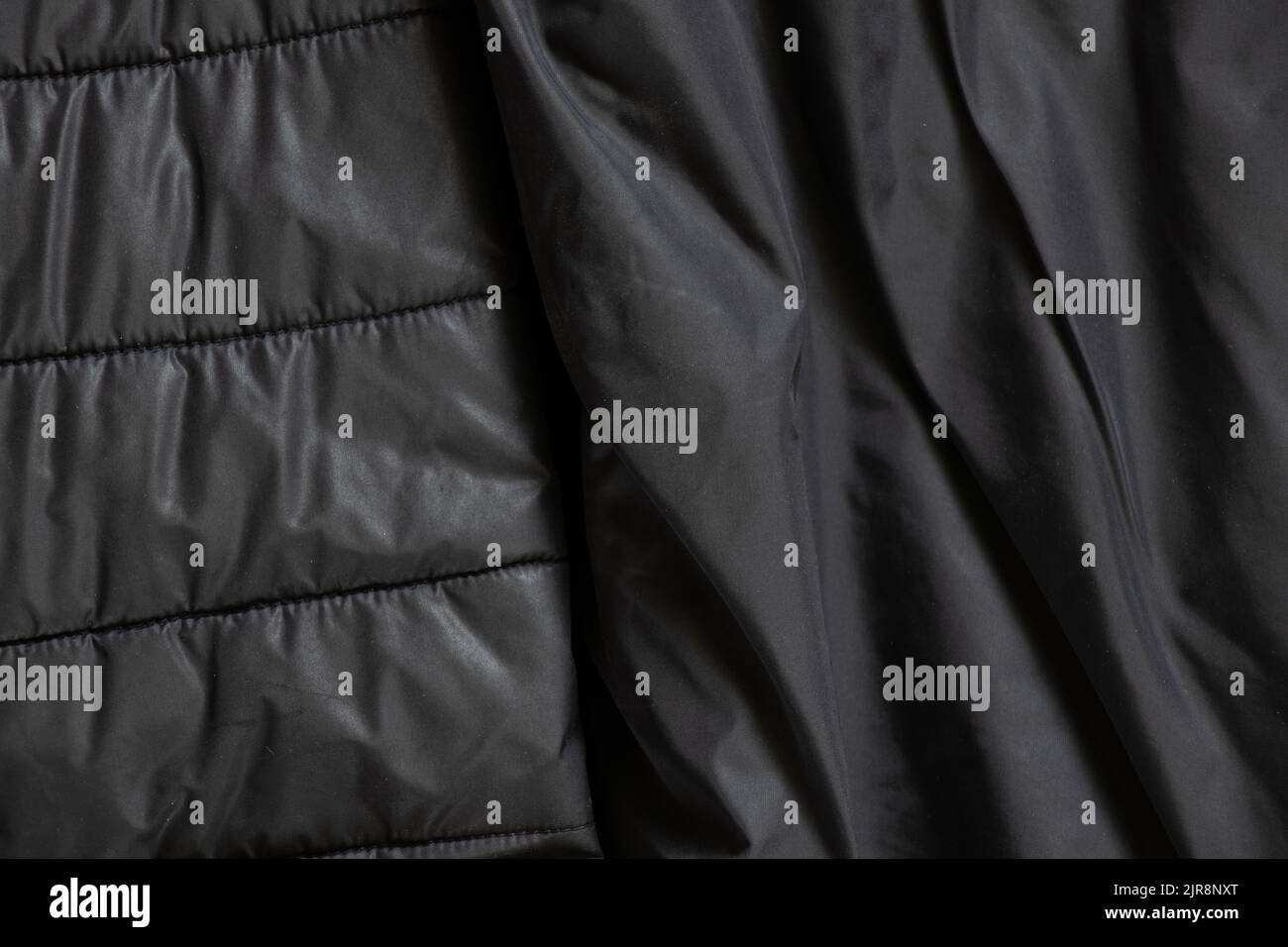 women's padded black padded jacket as background, background of soft ...