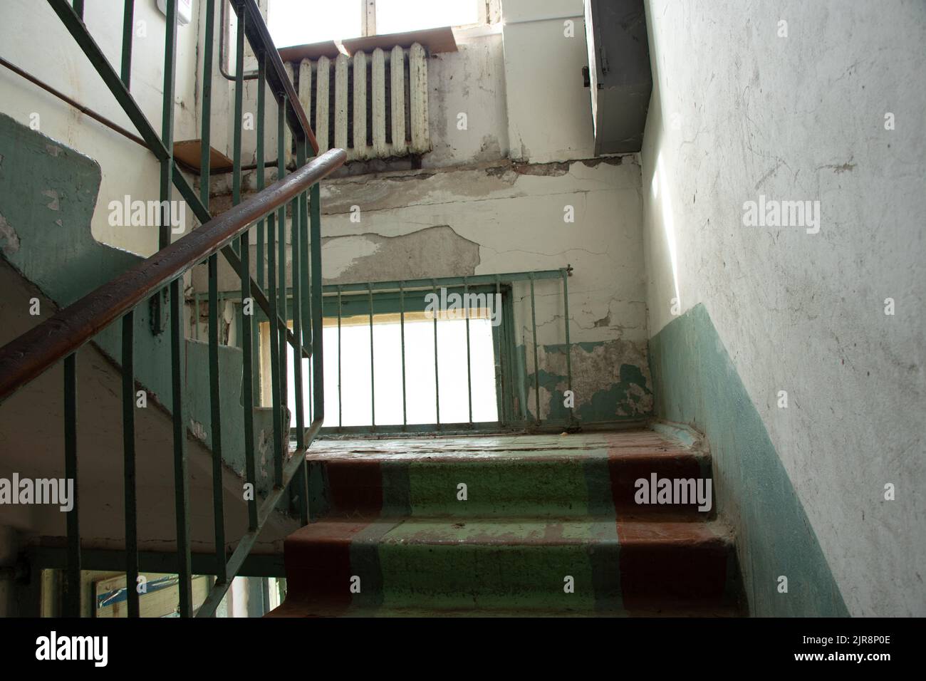 old dirty staircase without repair with a staircase in a residential ...