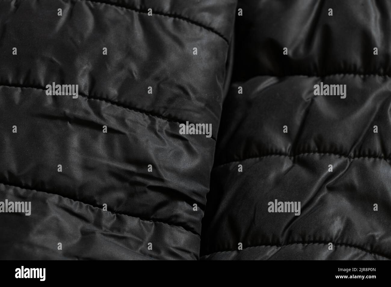 women's padded black padded jacket as background, background of soft ...