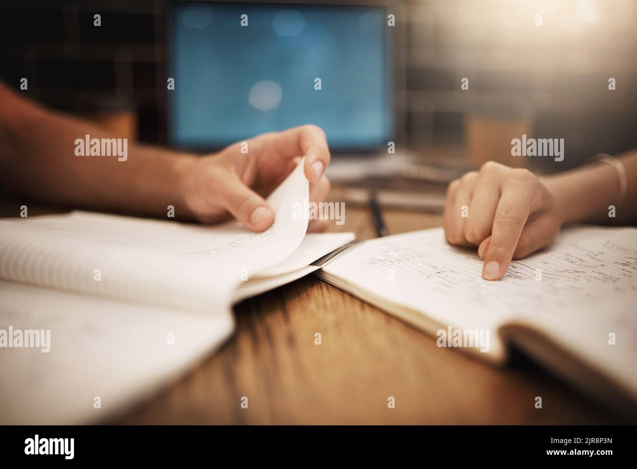 Going over their study material. two unrecognizable students having a ...