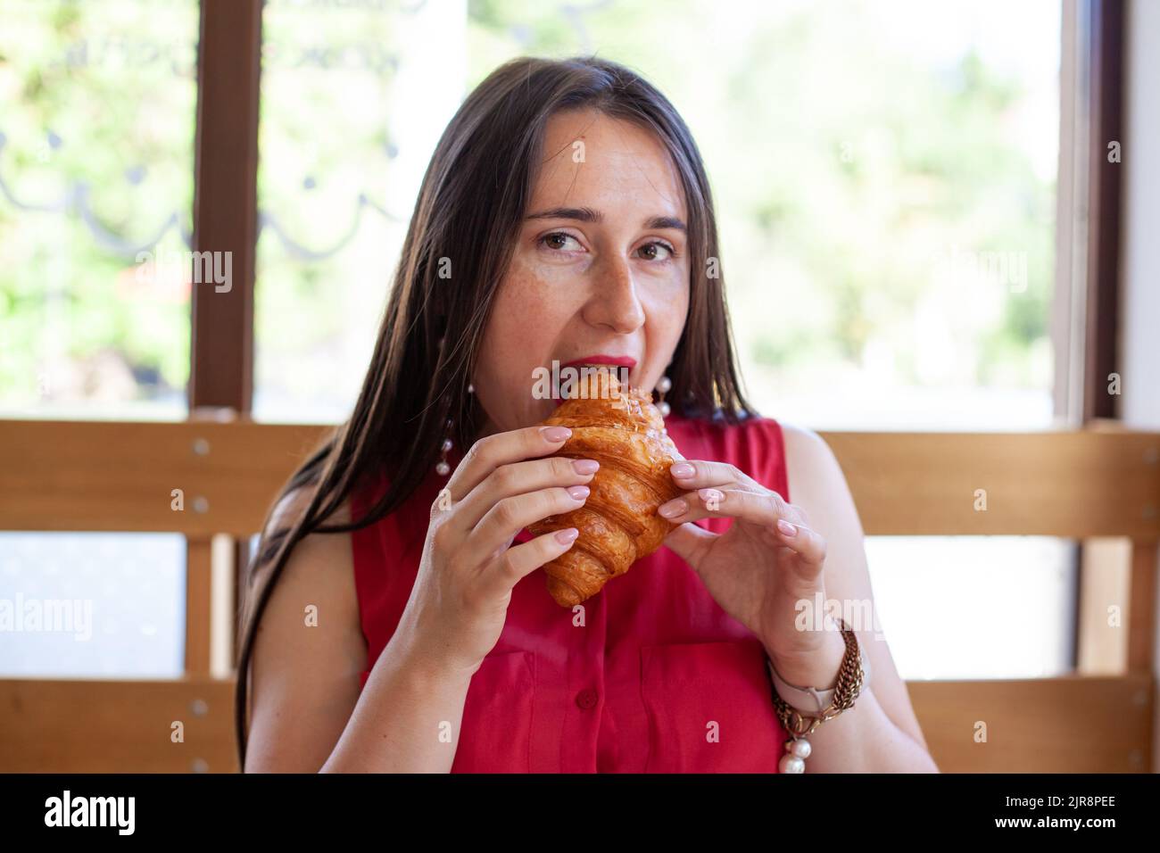 Croissant woman eating hi-res stock photography and images - Alamy