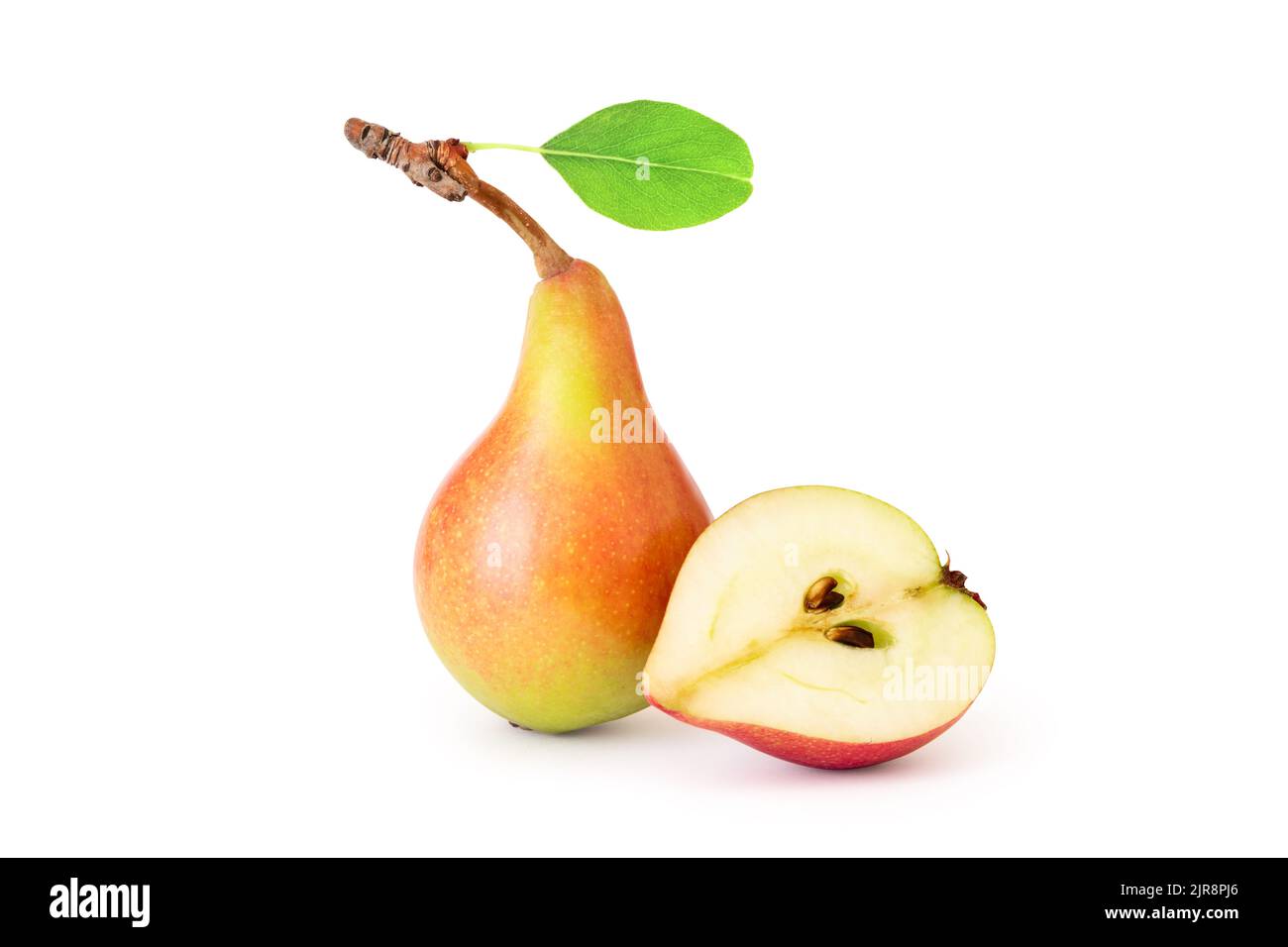 Sweet and ripe pear fruit with a halved and sliced one and a green leaf ...