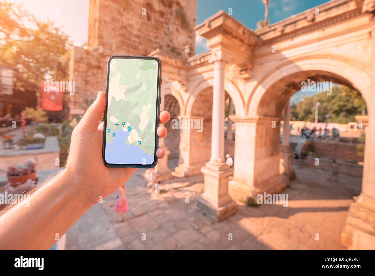 Hand with screen of smartphone with working maps and geolocation with ...