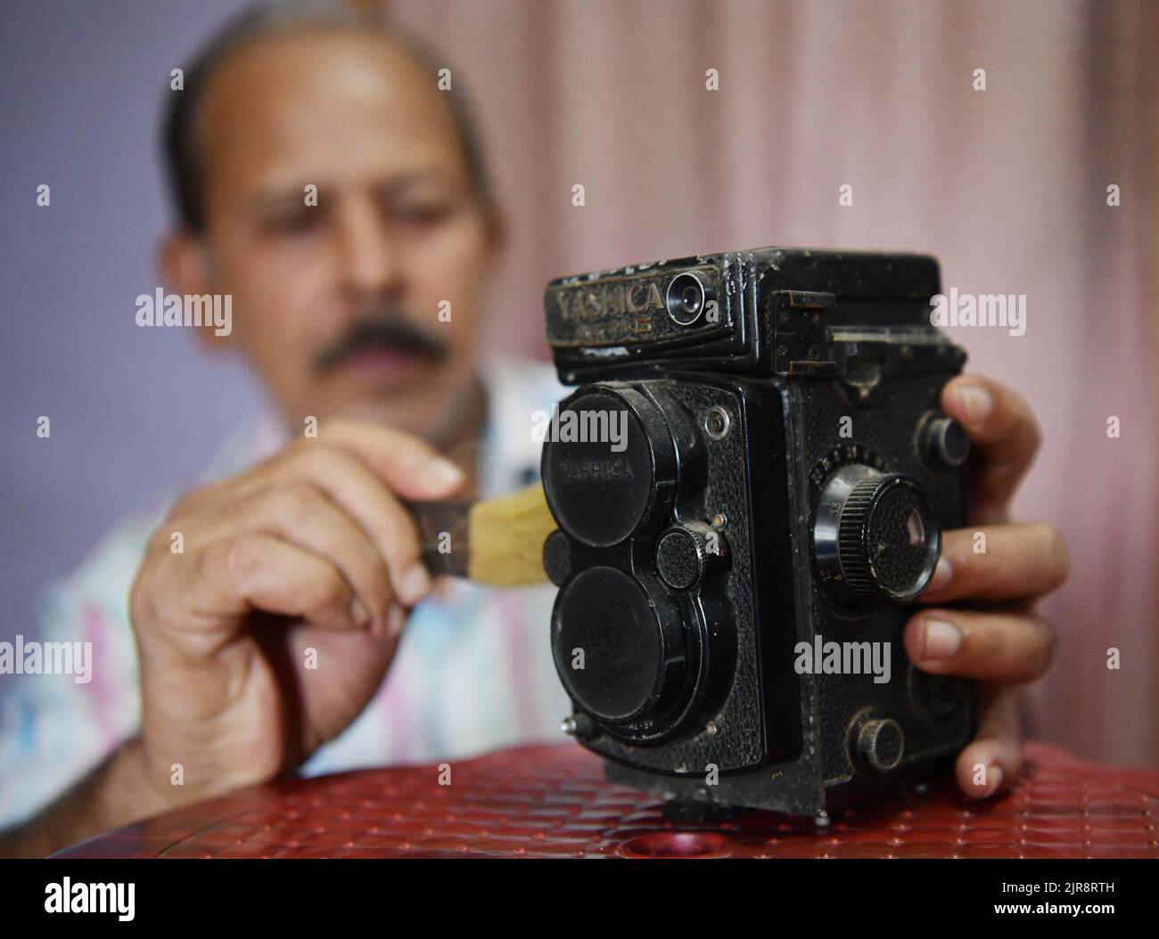 A Veteran photographer, Jhintu Sen cleans his old cameras on World ...