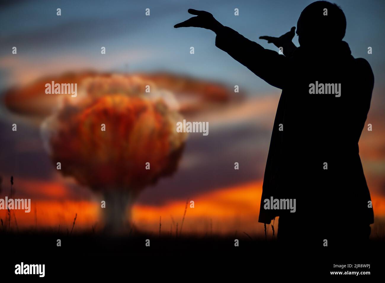 The concept of a nuclear strike. Silhouette of a man in a suit winking ...