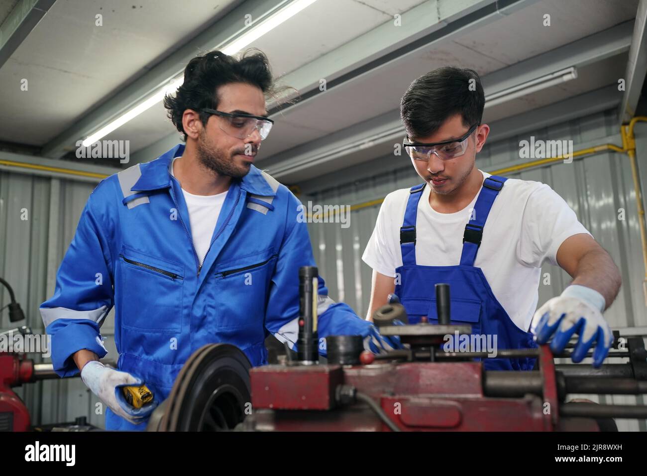 Workers changing and repair part of wheels at the car service Stock ...