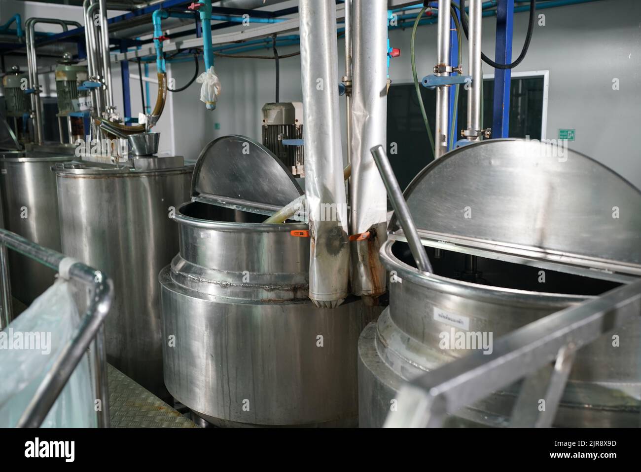 View of reservoires and soft drinks factory interior. worker ...