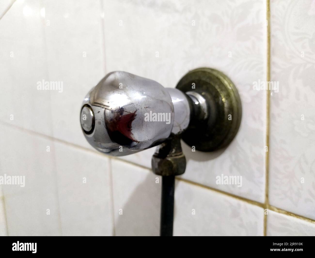steel tap in bathroom wall Stock Photo - Alamy
