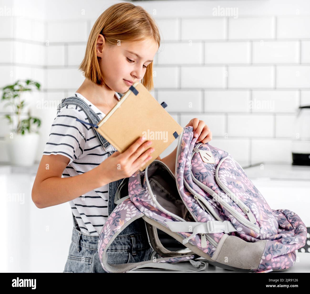 Girl preparing backpack Stock Photo - Alamy