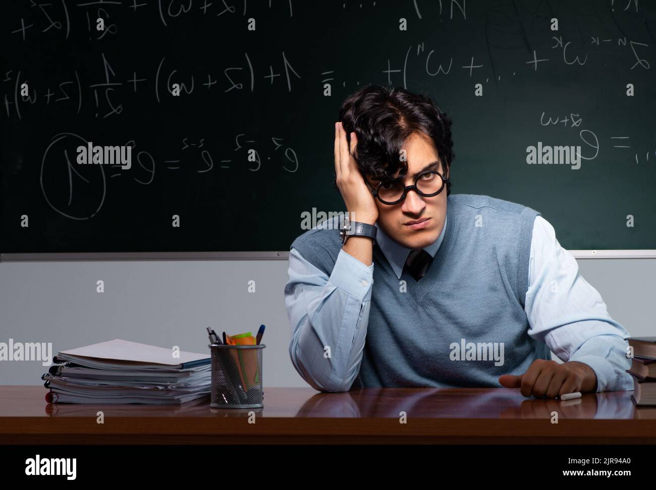 Young math teacher in front of chalkboard Stock Photo - Alamy