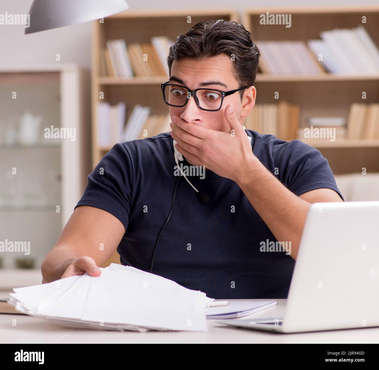 Angry man with too much paperwork to do Stock Photo - Alamy
