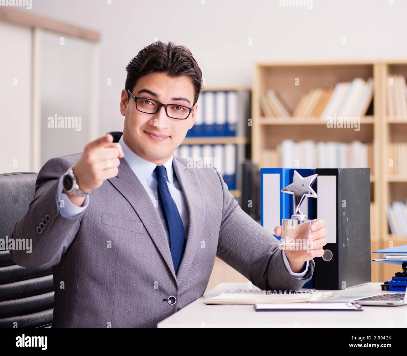 The businessman receiving award in the office Stock Photo - Alamy