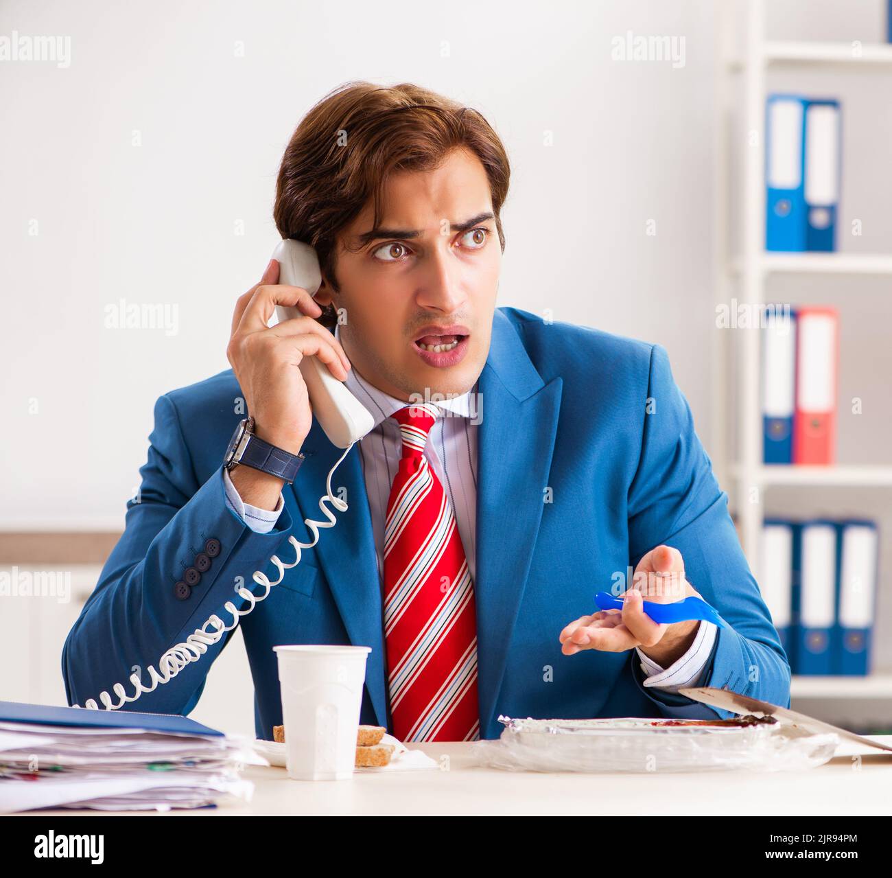 Man having meal at work during break Stock Photo - Alamy