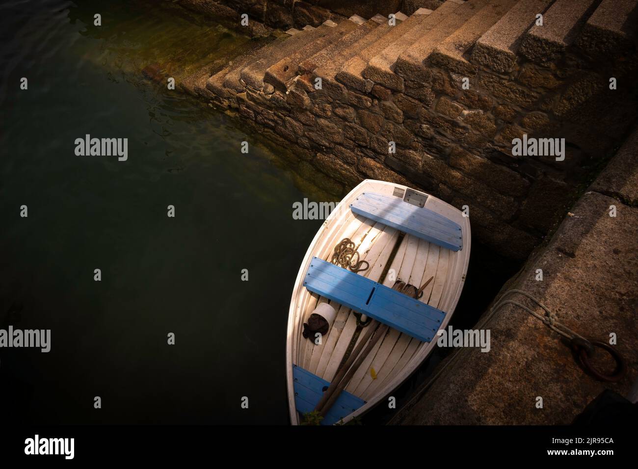 Close up of white rowing boat parking Stock Photo - Alamy