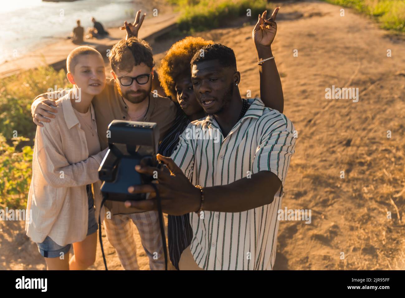 Multi-ethnic group of best friends creating memories by taking funny ...