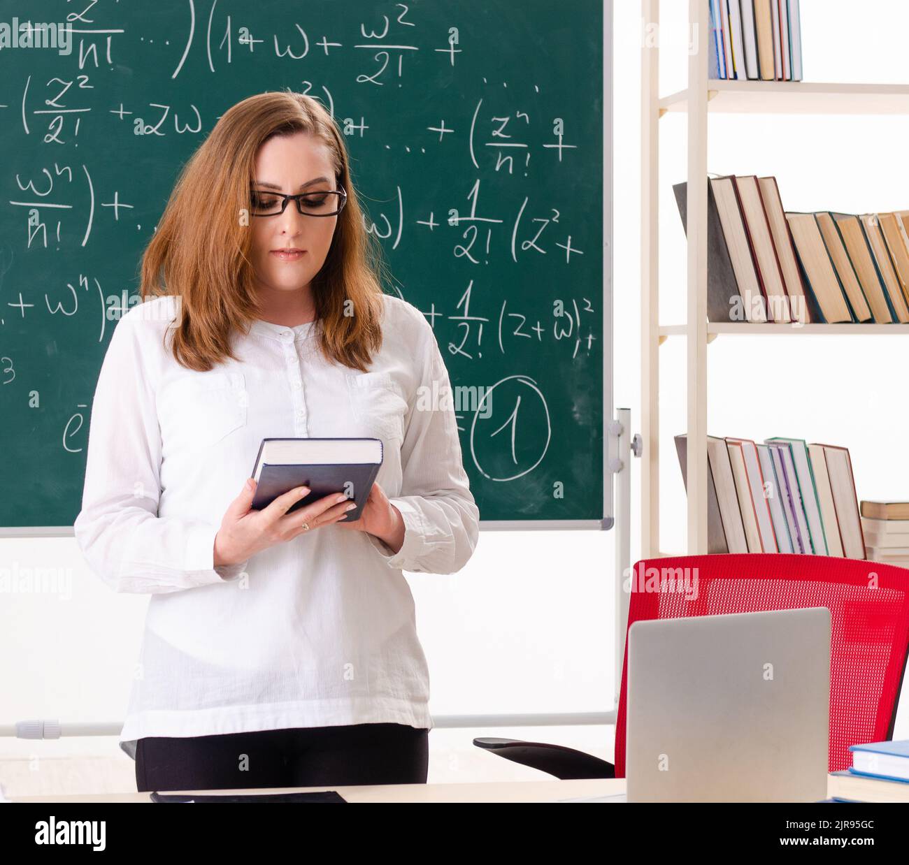 Female math teacher in the classroom Stock Photo - Alamy