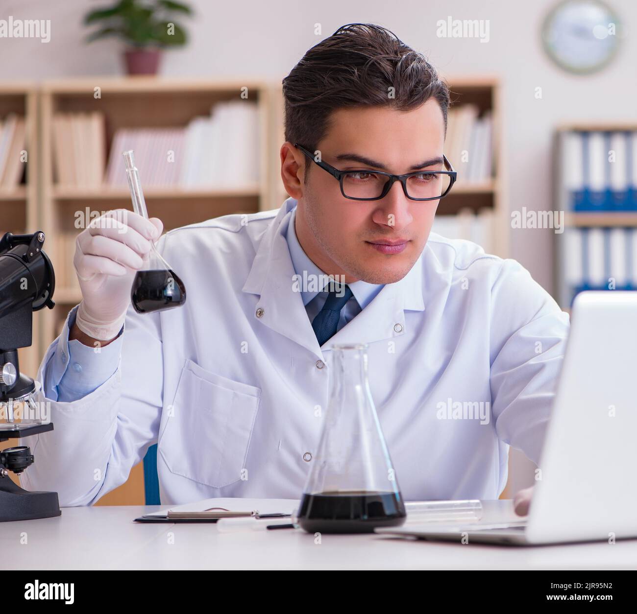The young lab assistan working in the laboratory Stock Photo - Alamy