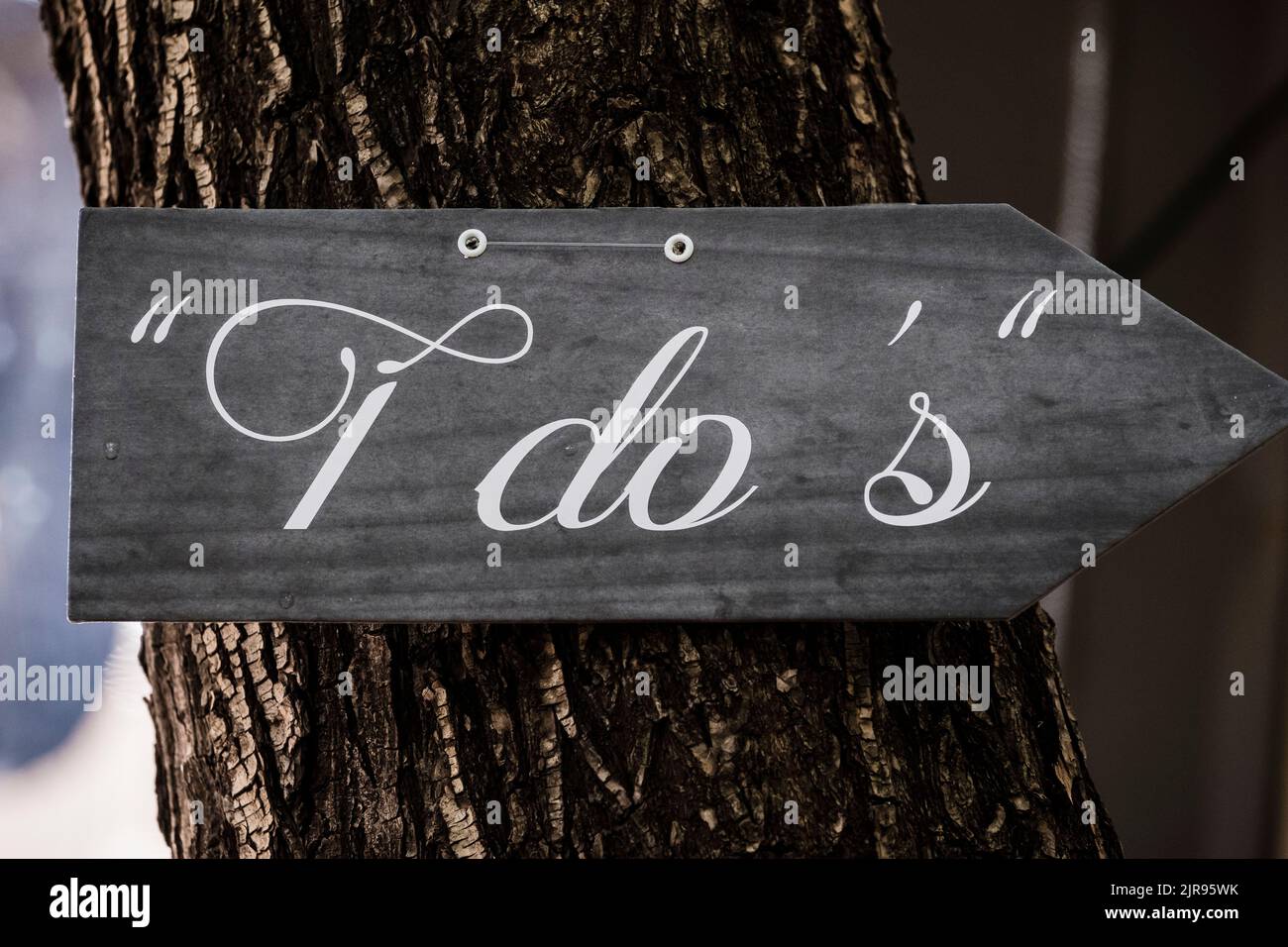 A closeup shot of a black wooden "I do's" sign for a wedding Stock ...