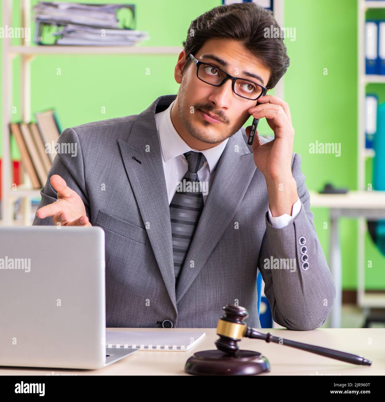 The young handsome lawyer working in the office Stock Photo - Alamy