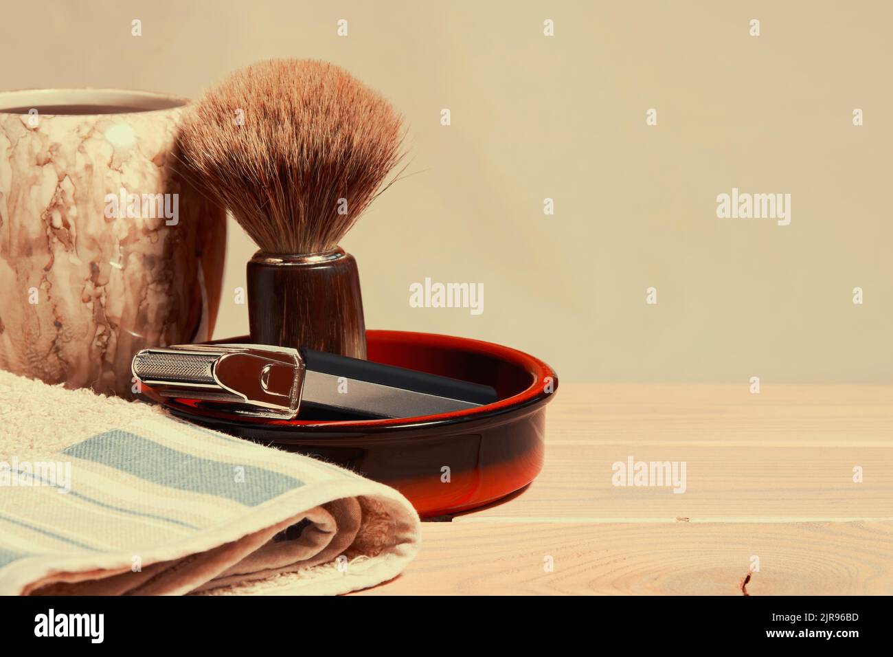 Toned image with vintage shaving equipment, razor blade and brush on ...