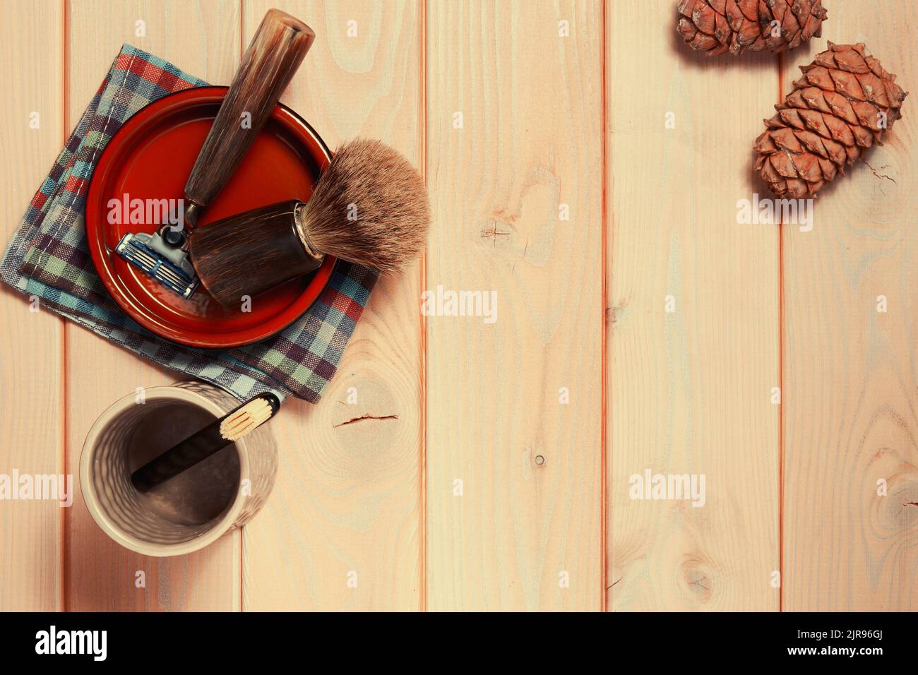Toned flat lay with natural shaving equipment, razor blade and brush on ...