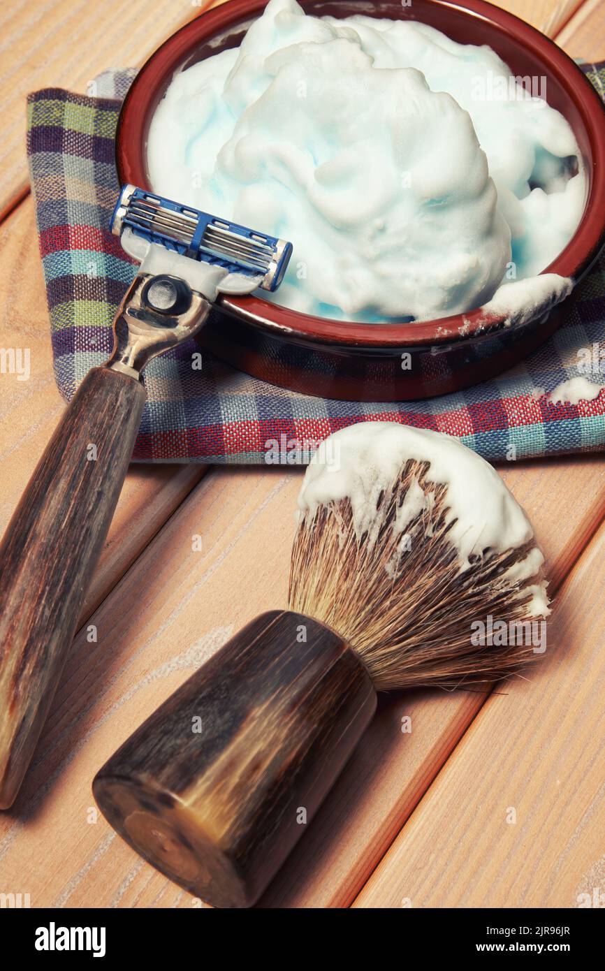 Vintage toned shaving eqip, razor blade, brush, gel on the wooden table ...
