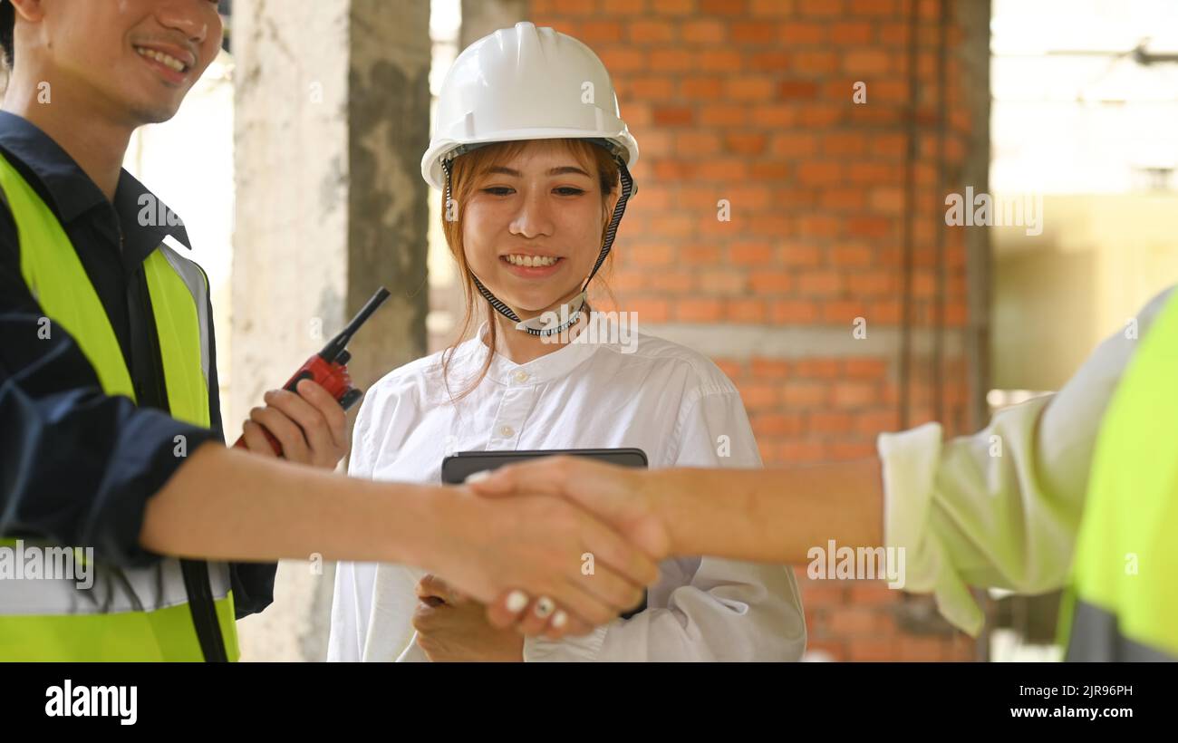 Cropped view of investor and engineer shaking hands for real estate ...