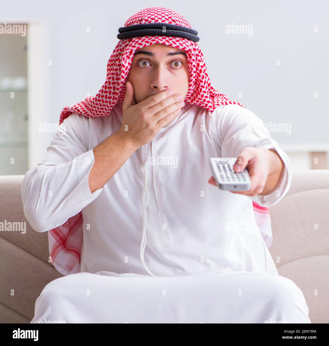 The arab man watching tv at home Stock Photo - Alamy