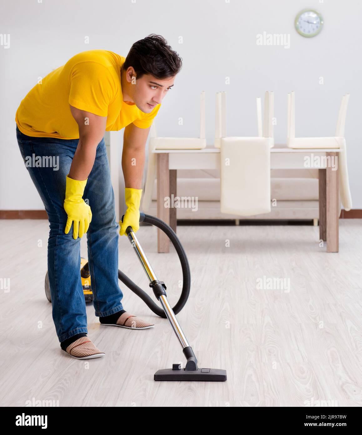 The man husband cleaning the house helping his wife Stock Photo - Alamy