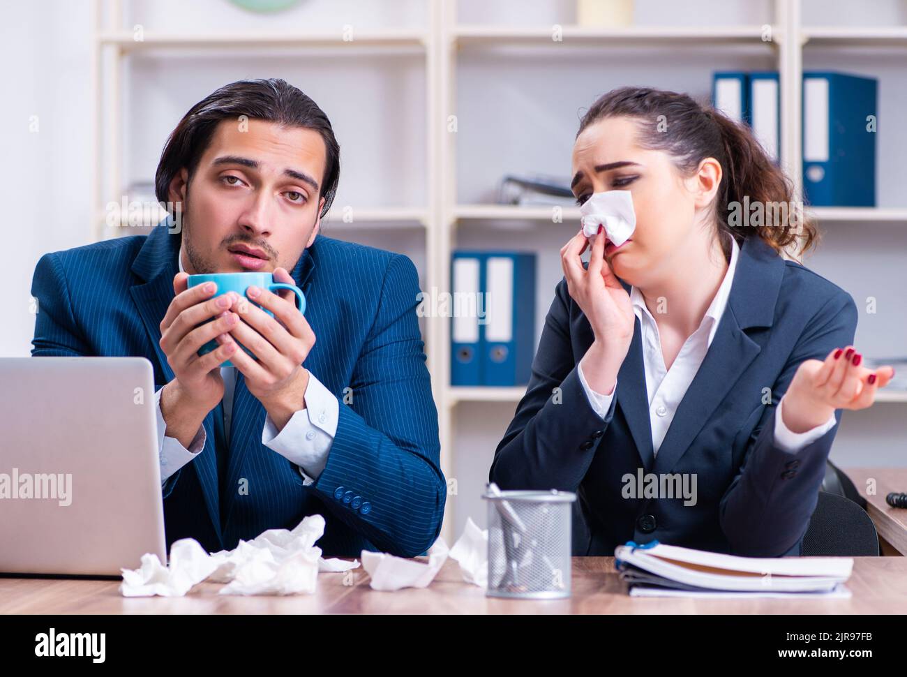The two employees suffering at workplace Stock Photo - Alamy