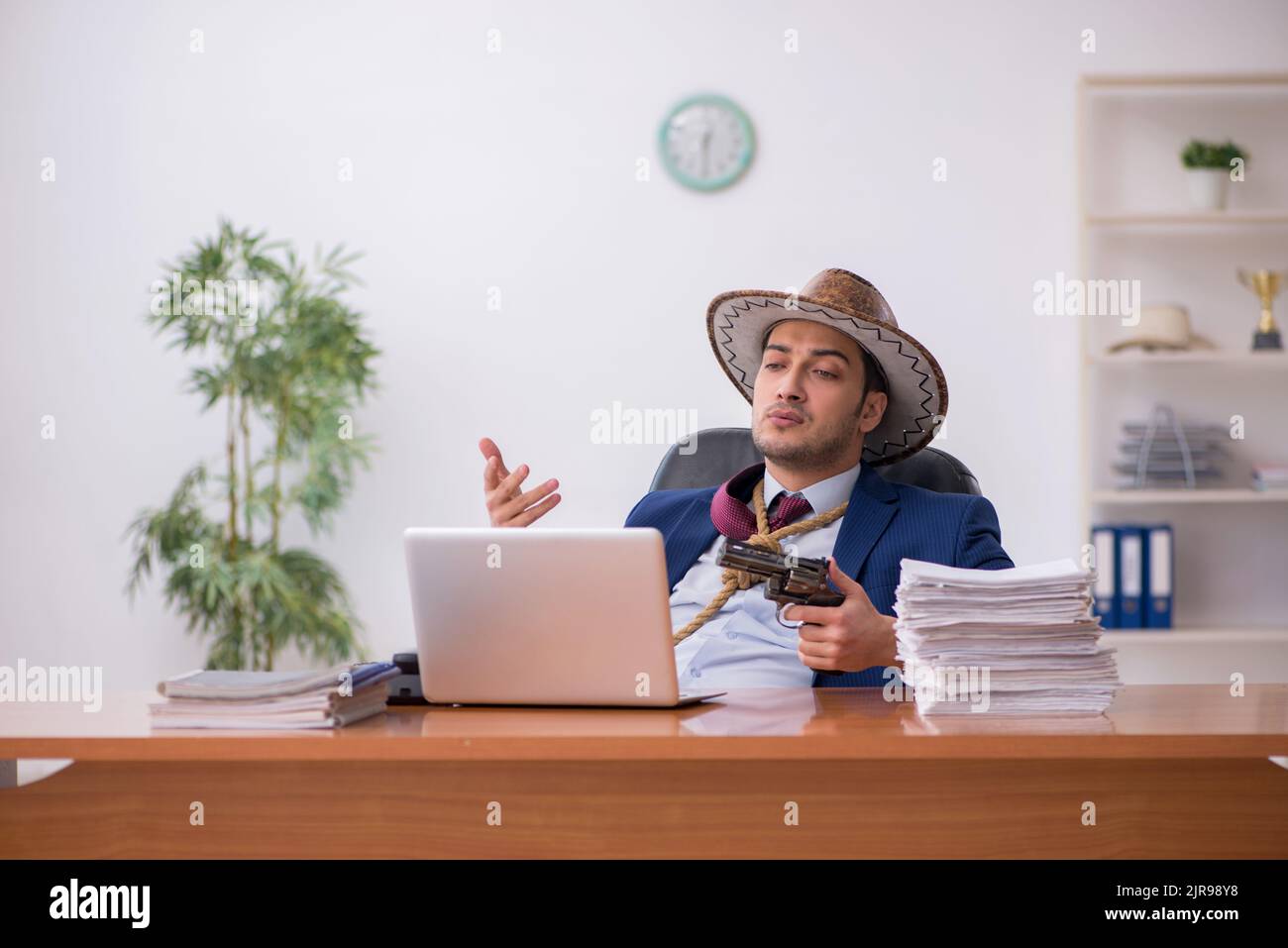 Young cowboy employee working at workplace Stock Photo - Alamy