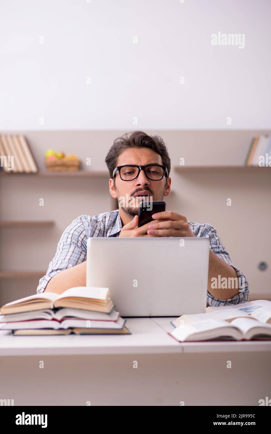 Young student preparing for exams at home Stock Photo - Alamy