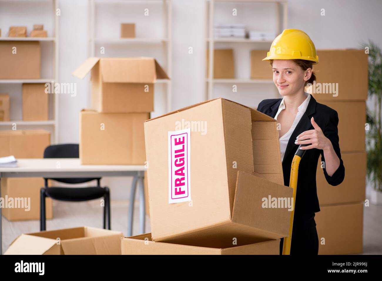 Female professional mover doing home relocation Stock Photo - Alamy