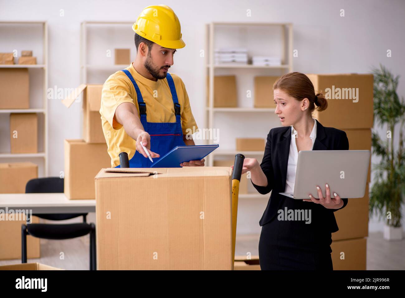Female boss and male contractor doing home relocation Stock Photo - Alamy