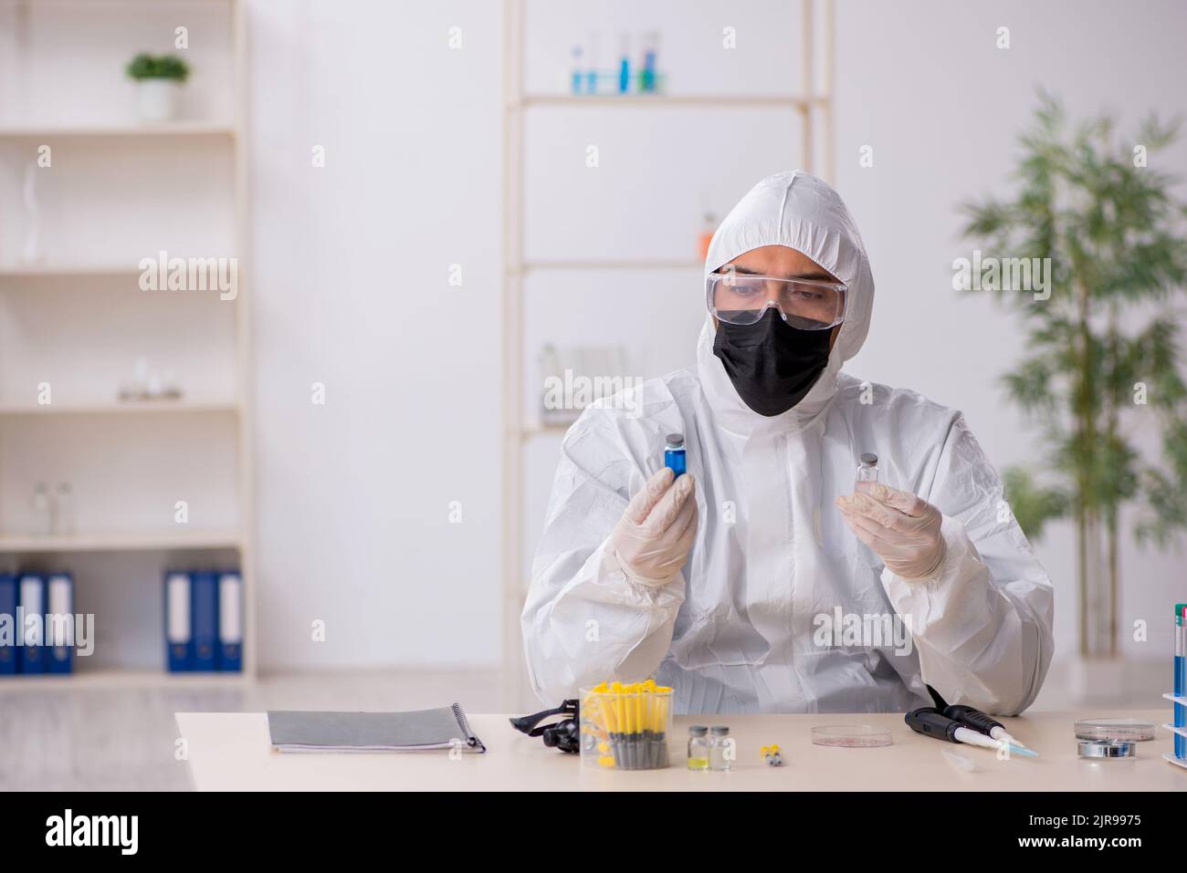 Young chemist working at the lab during pandemic Stock Photo - Alamy