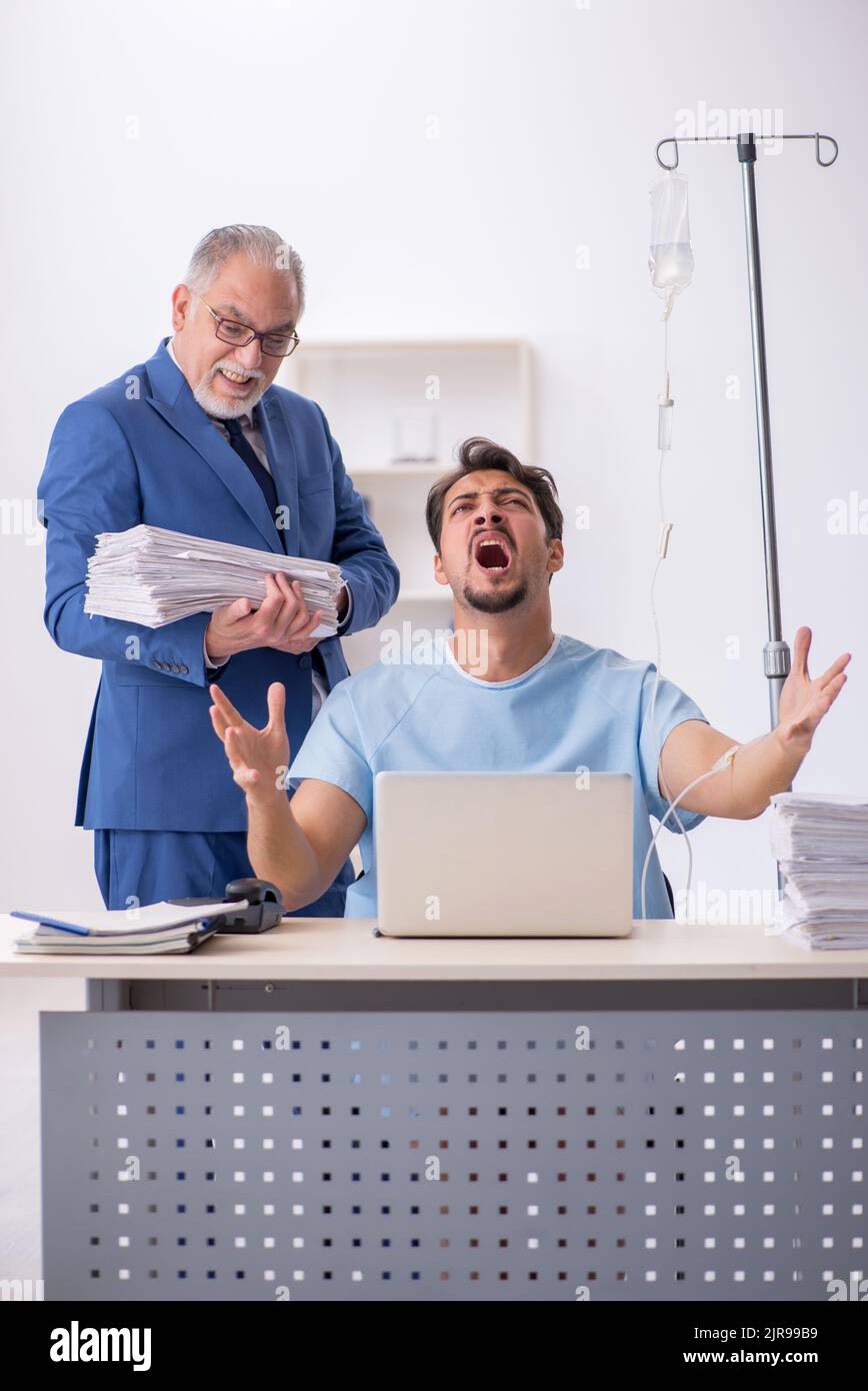 Young employee feeling bad at workplace Stock Photo - Alamy