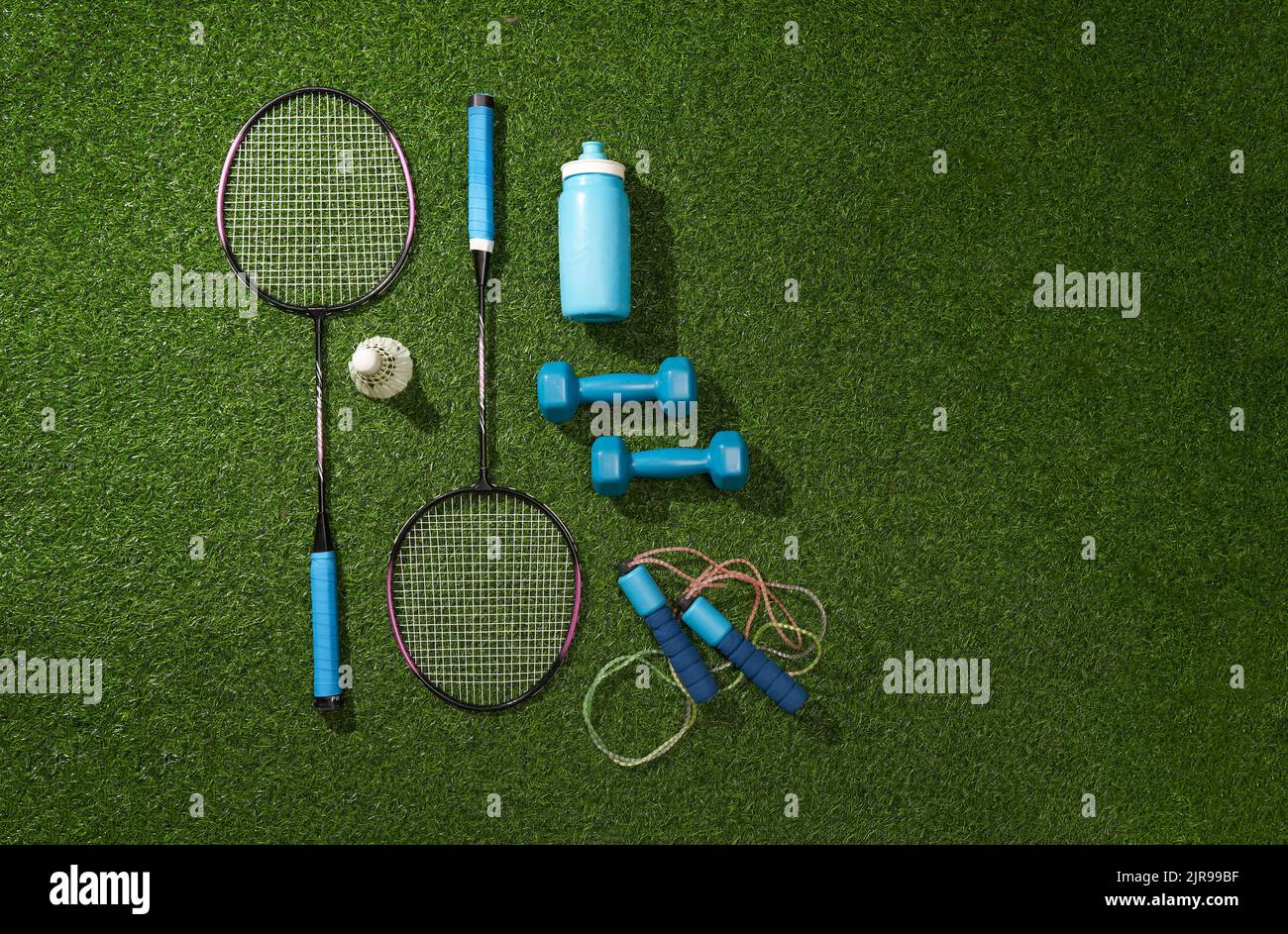 Set of different sports equipment on green grass background. Flat lay ...