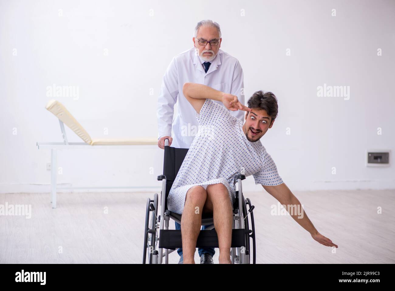 Old doctor psychiatrist examining young disabled patient Stock Photo ...