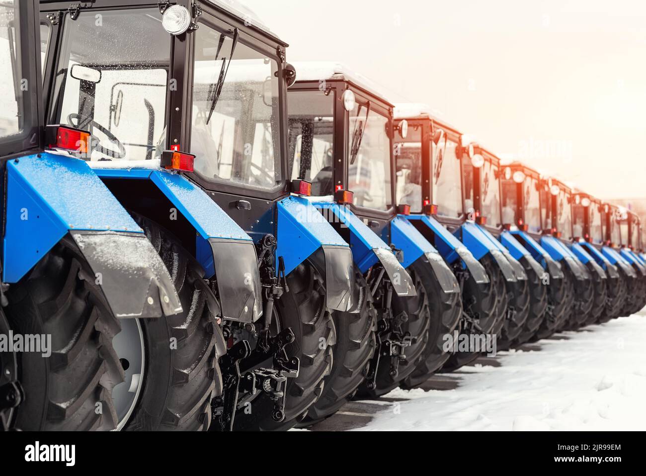 Many different tractors standing in row at agricultural fair for sale ...
