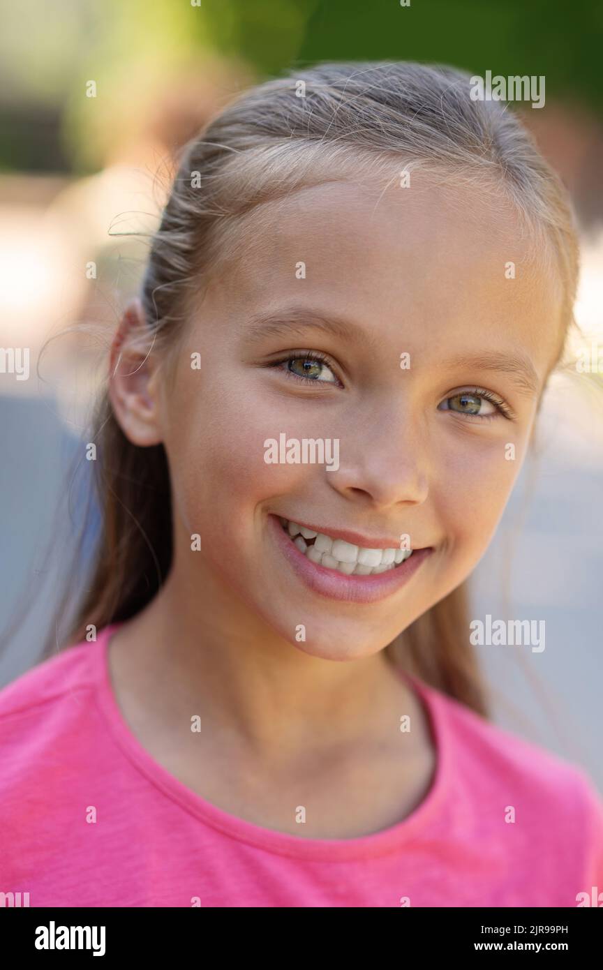 Face of pretty girl with toothy smile Stock Photo - Alamy