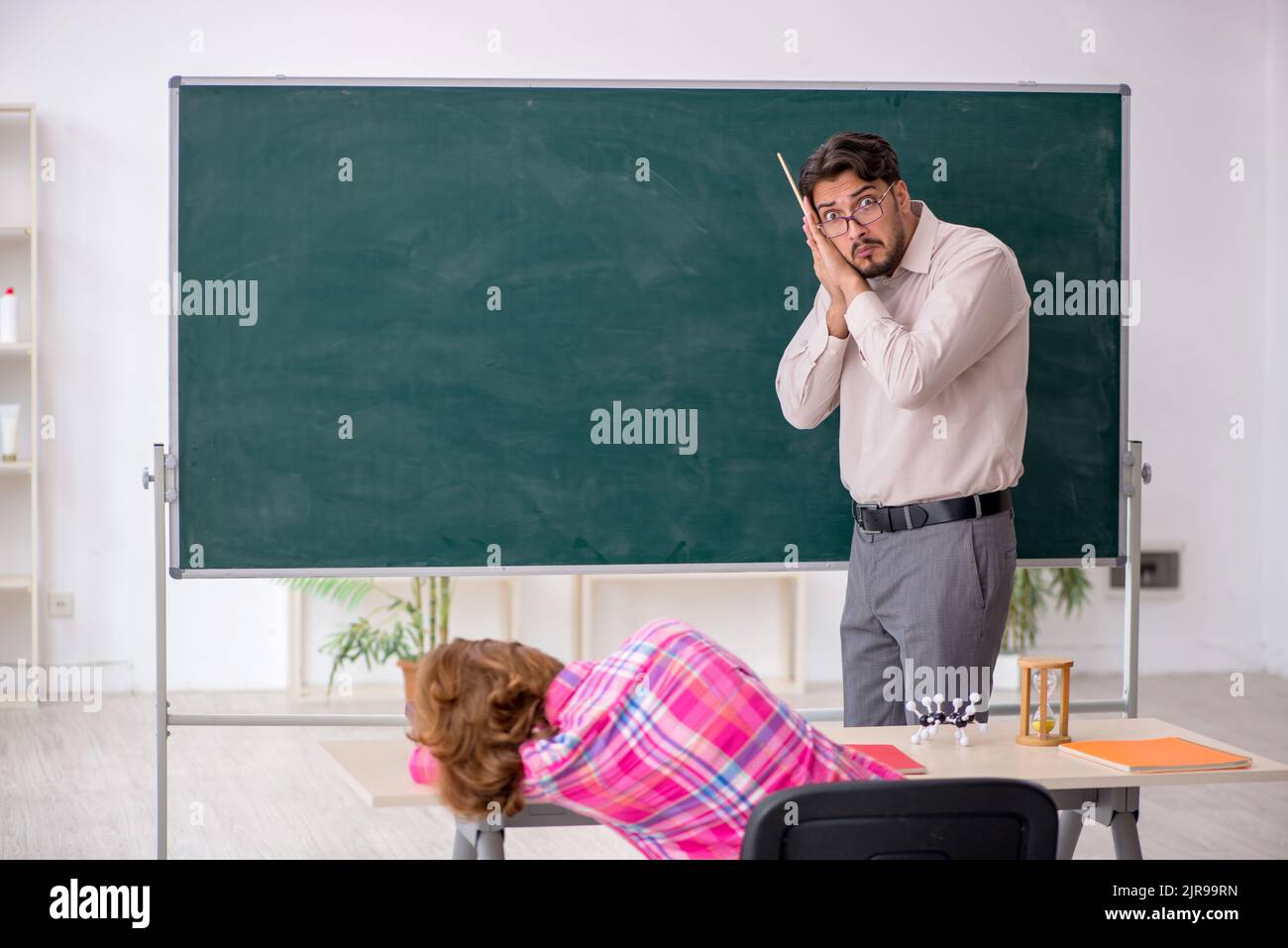 Young teacher and redhead girl in the classroom Stock Photo - Alamy