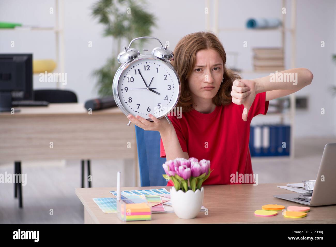 Female designer in time management concept Stock Photo - Alamy