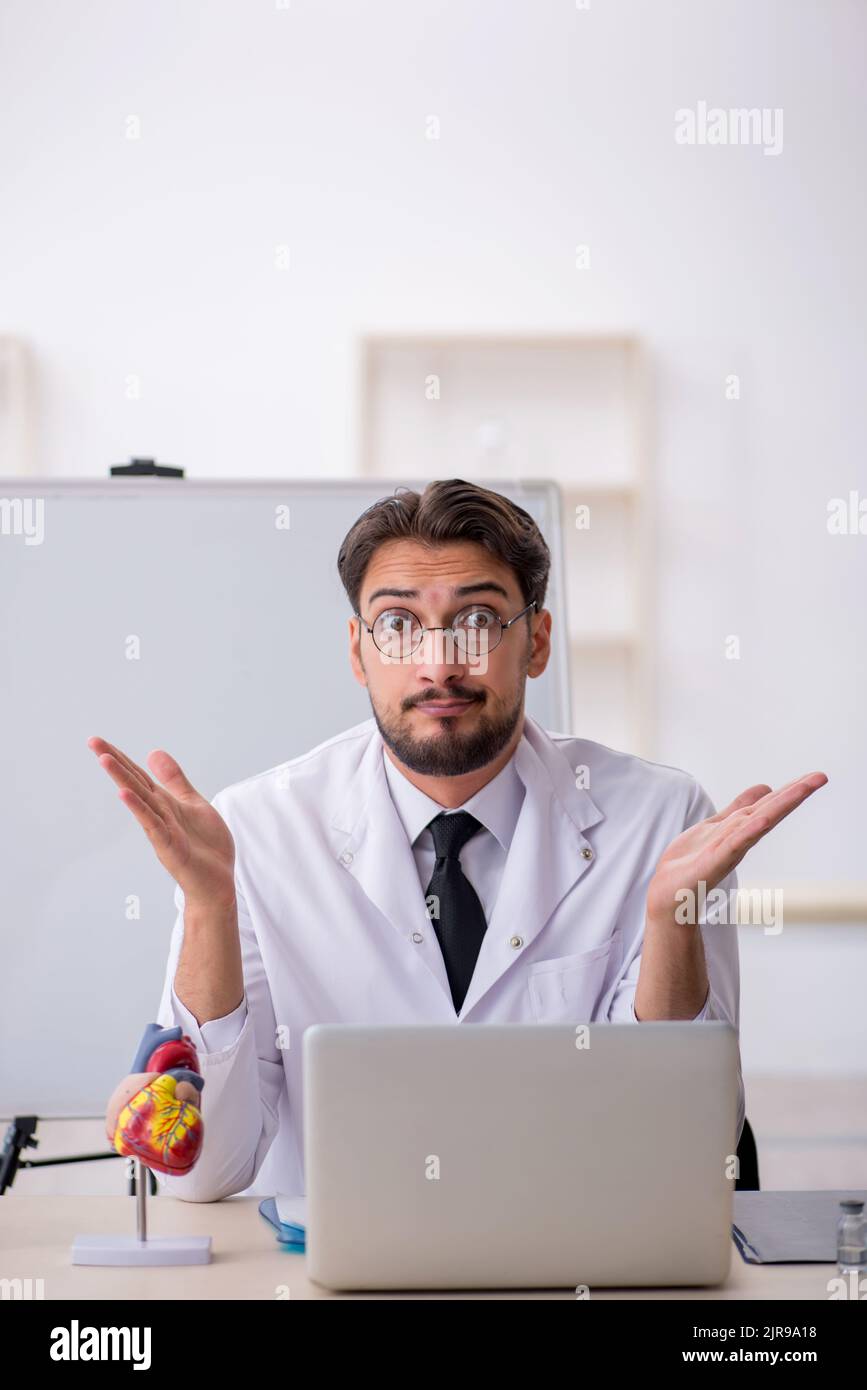 Young doctor cardiologist in front of whiteboard Stock Photo - Alamy