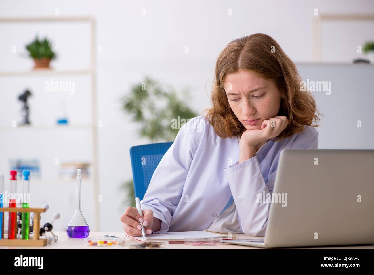 Young girl chemist working at the lab Stock Photo - Alamy