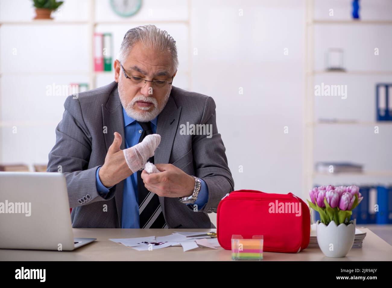 Old businessman employee cutting his hand at workplace Stock Photo - Alamy