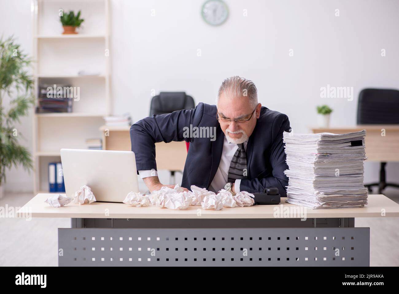 Old businessman employee in brainstorming concept Stock Photo - Alamy