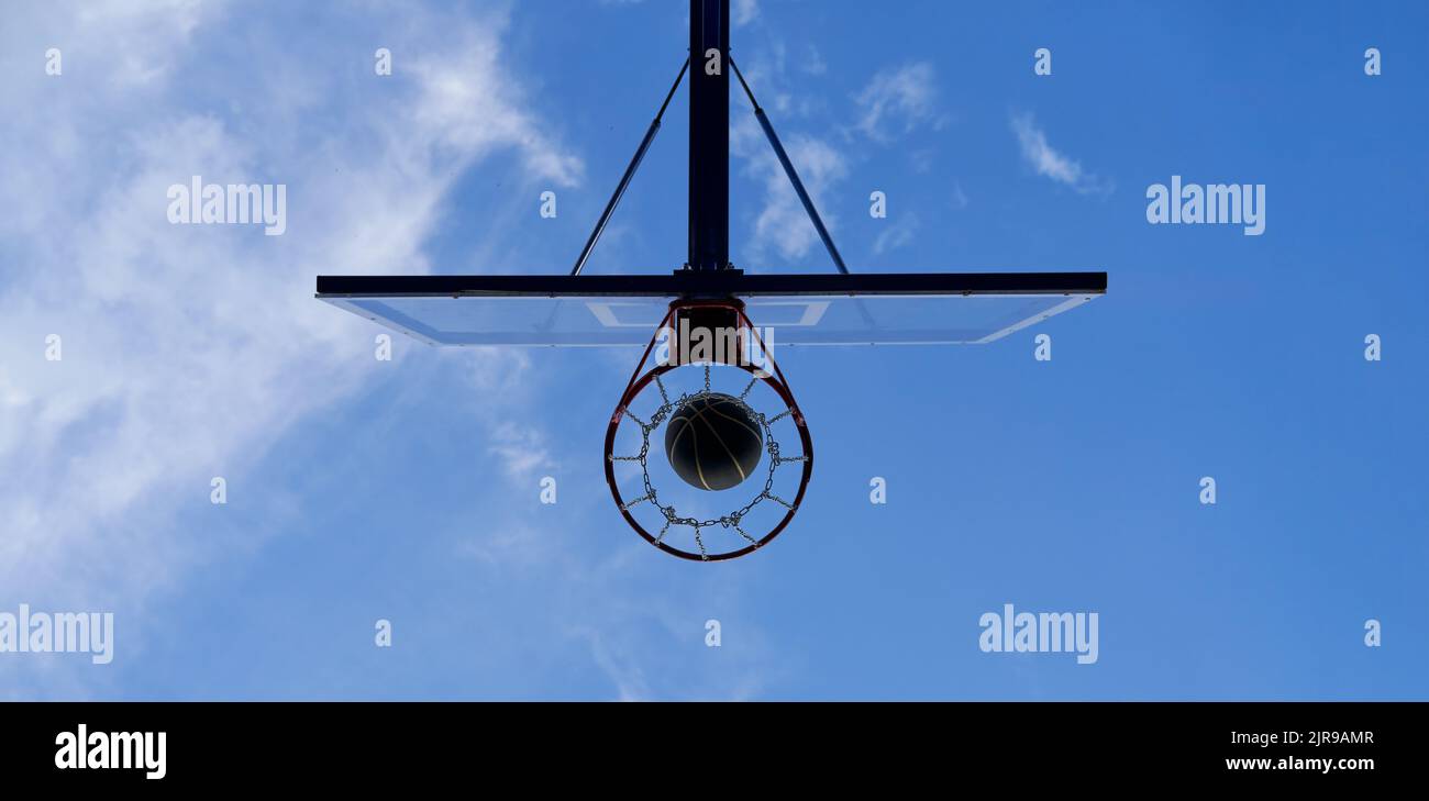 Street basketball ball falling into the hoop. Concept of success ...