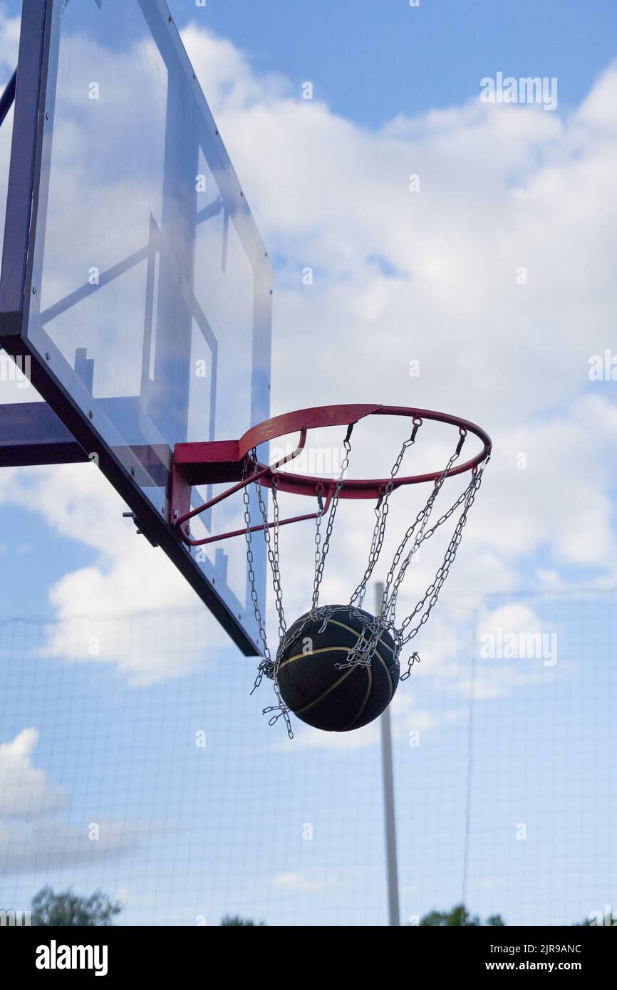 Street basketball ball falling into the hoop. Urban youth game. Concept ...