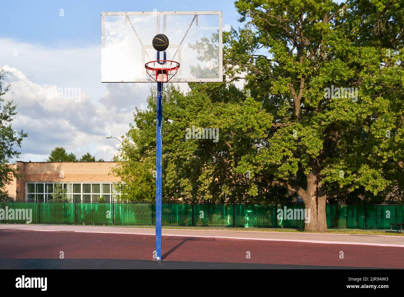 Street basketball ball falling into the hoop. Street basketball in the ...