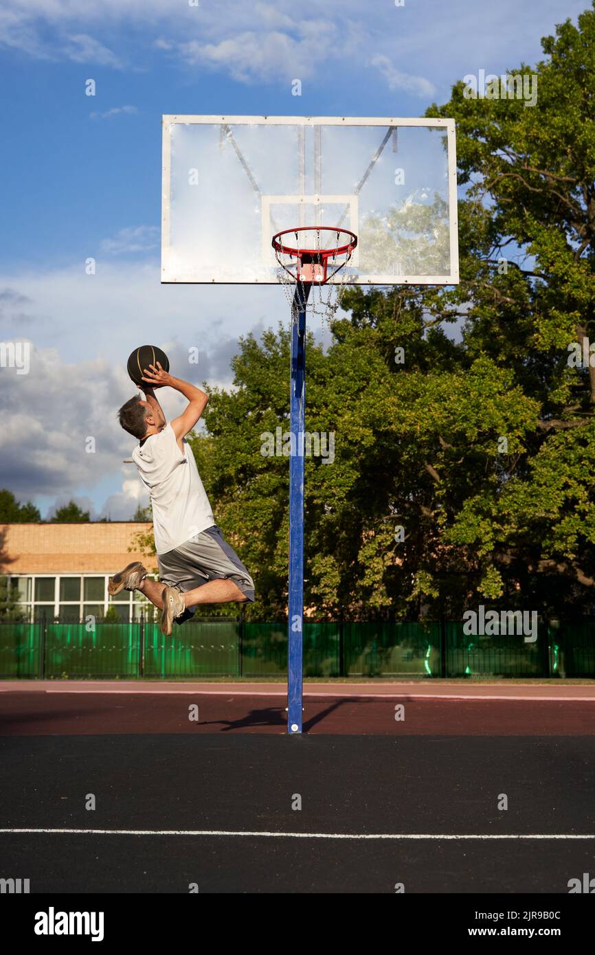Basketball player in action flying high and scoring. Training of ...